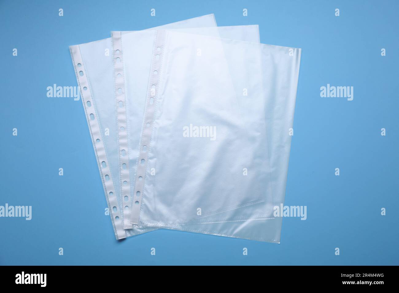 Punched pockets on light blue background, flat lay Stock Photo - Alamy