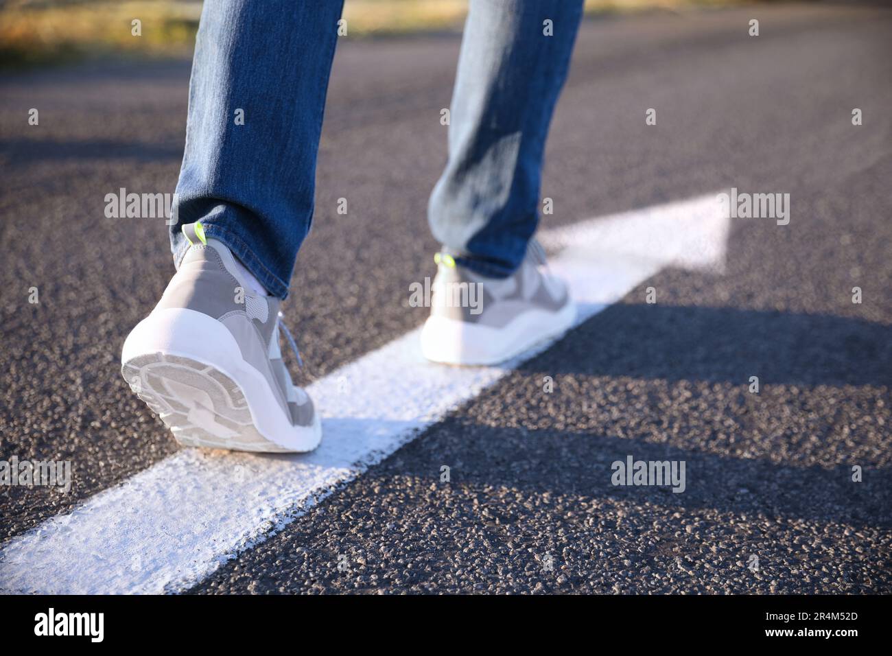 Planning future. Man walking on drawn mark on road, closeup. White ...