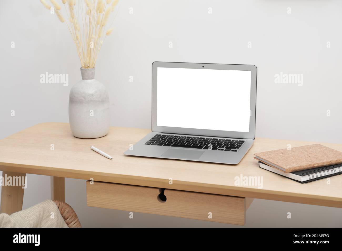 Comfortable workplace at home. Modern laptop with blank screen and ...