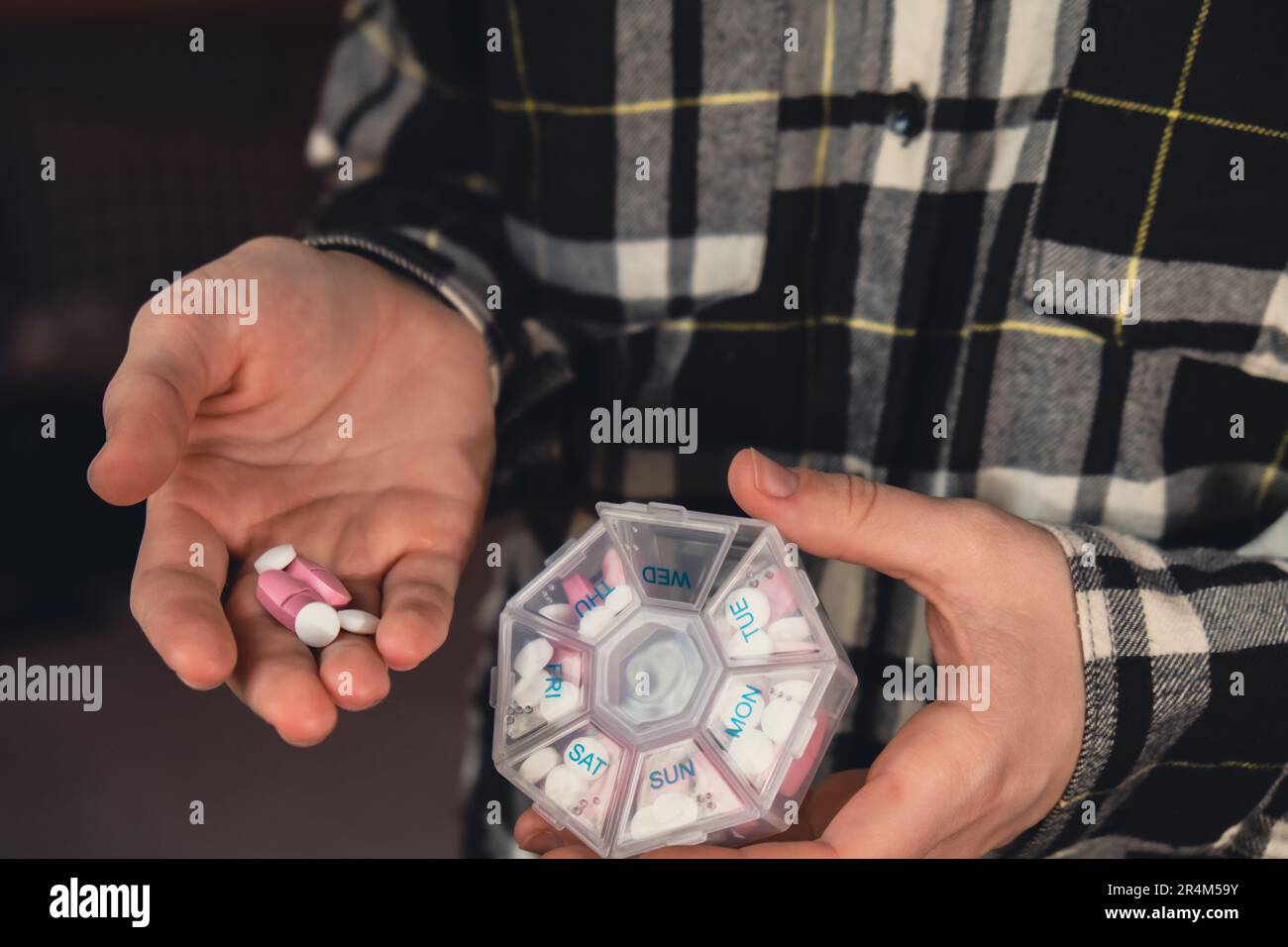 Female hands sorting pills Organizer weekly shots Closeup of medical ...