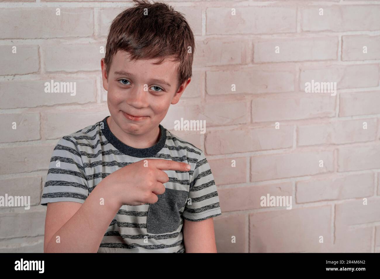 cute caucasian boy point index finger aside on area workspace Stock ...