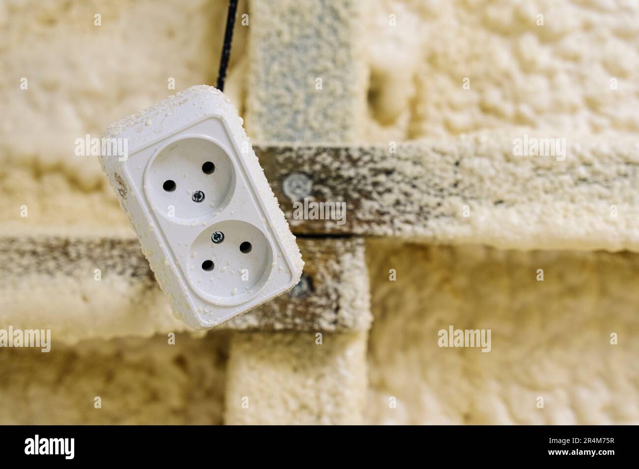 Electrical outlet hanging on a wire in the workshop Stock Photo - Alamy
