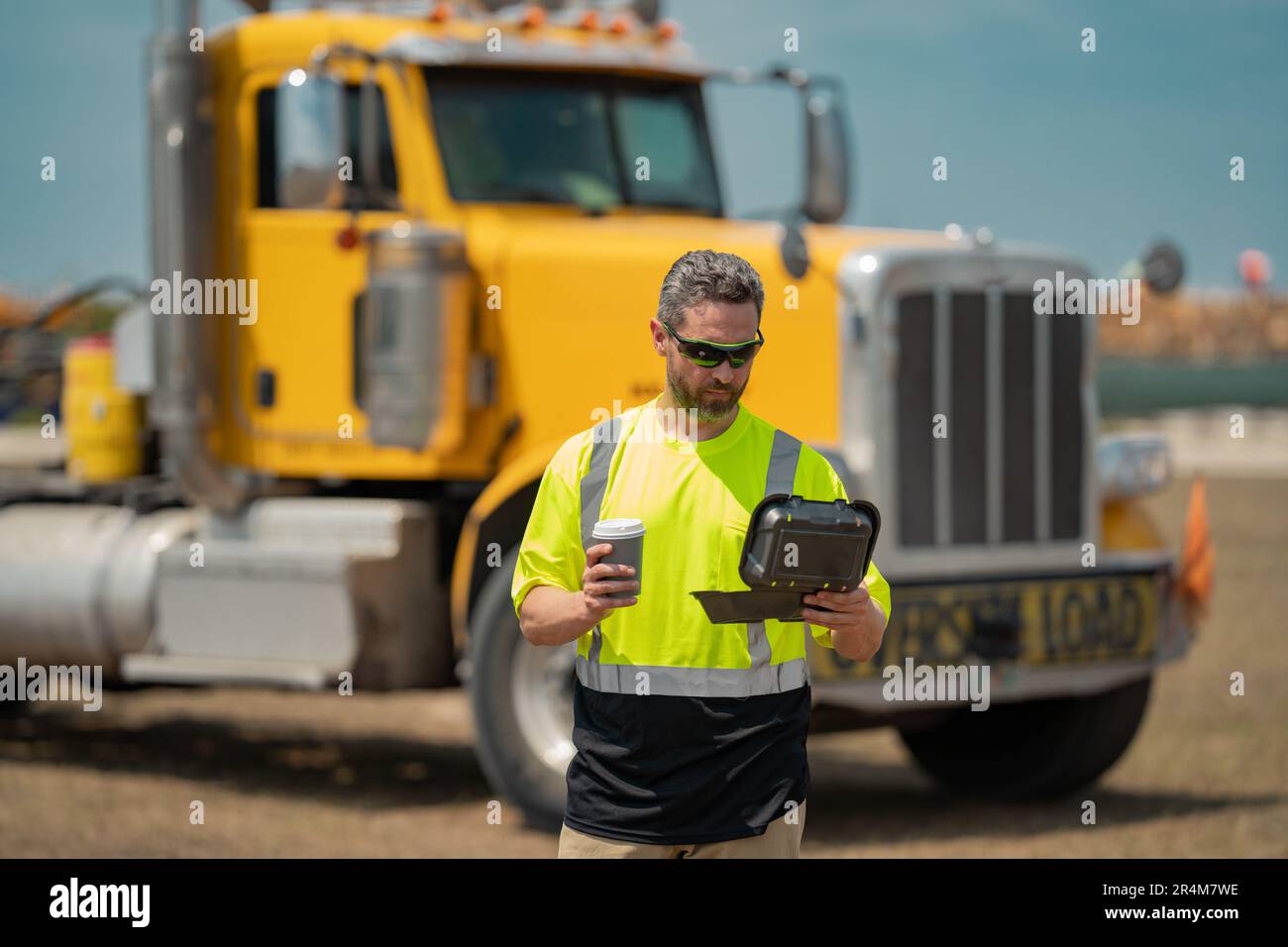 Men driver near lorry trucks. Man owner truck driver in safety vest ...