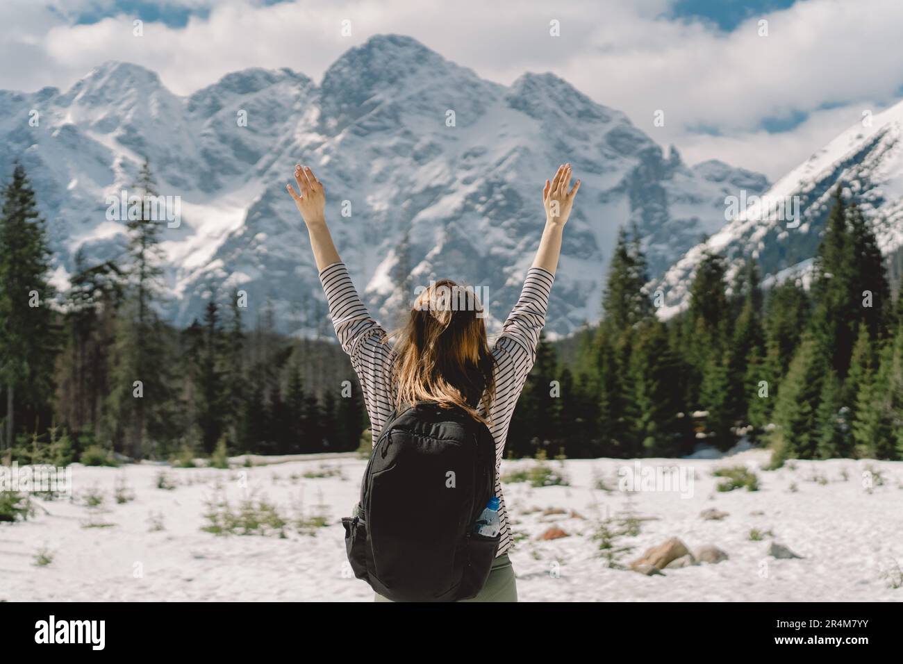 Back view of a girl traveler wearing a backpack traveling alone Stock ...