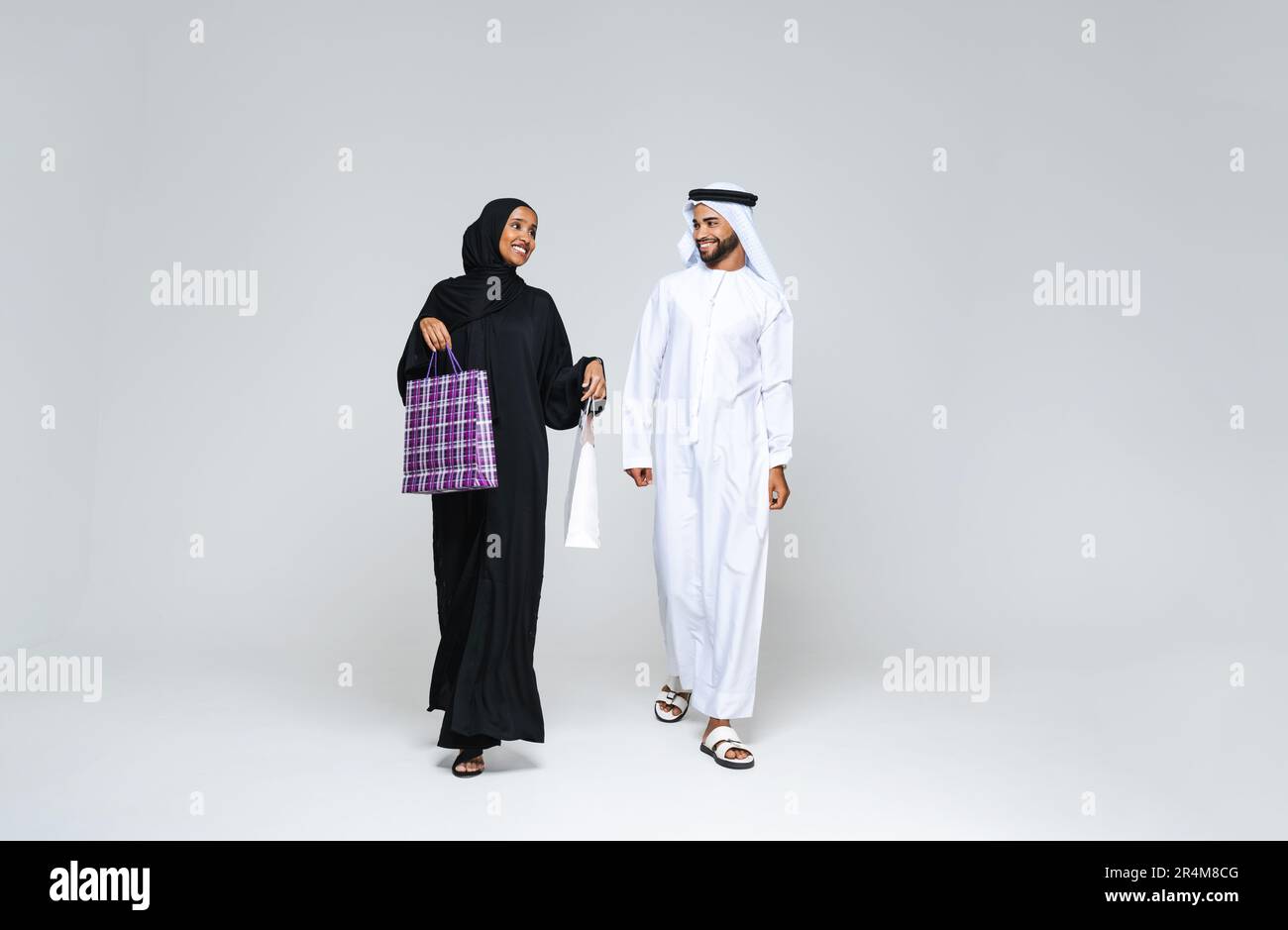 Beautiful arab middle-eastern happy couple of lovers wearing traditional abaya and kandora in ...