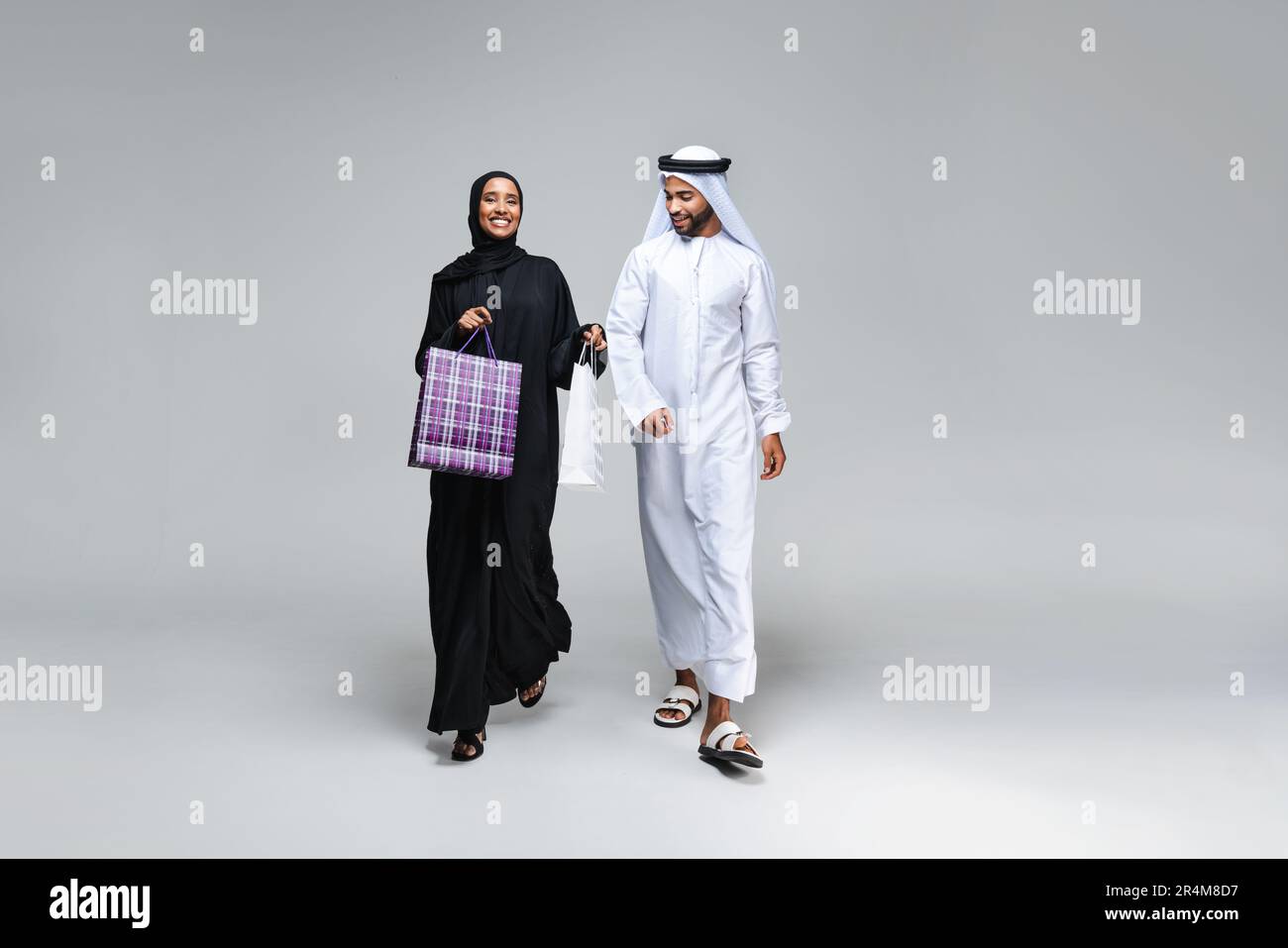 Beautiful arab middle-eastern happy couple of lovers wearing traditional abaya and kandora in ...