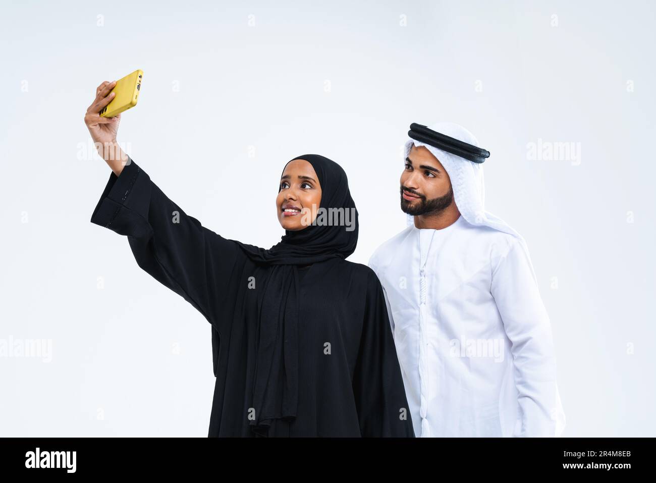Beautiful arab middle-eastern happy couple of lovers wearing traditional abaya and kandora in ...