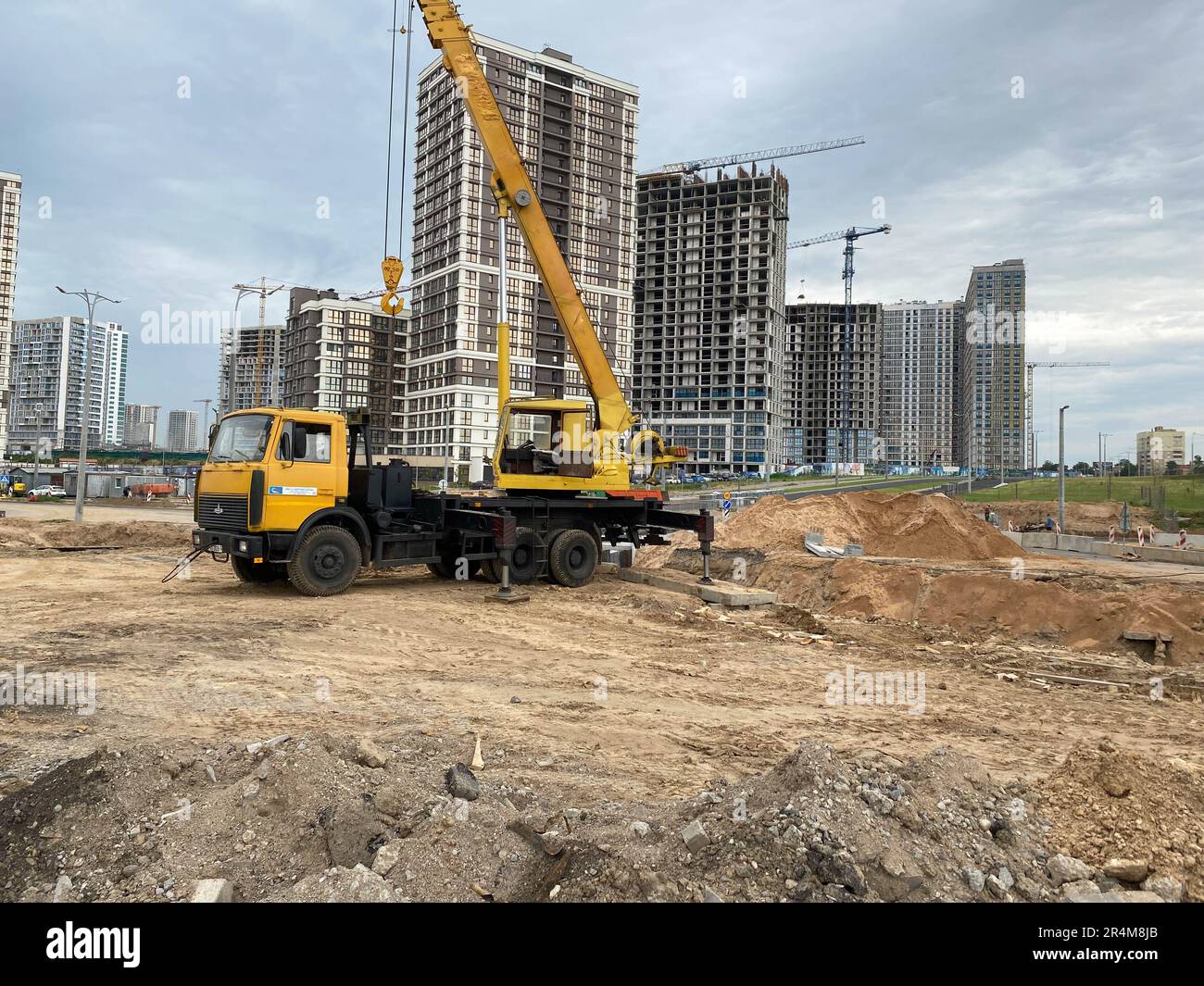 Workers engineers working at construction site and cranes on background ...