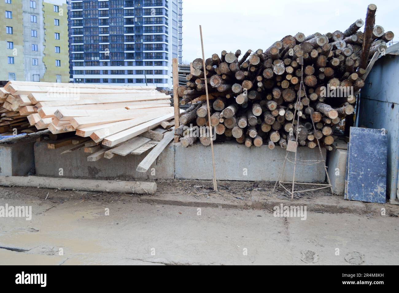 A lot of long wooden natural planed logs and boards at a sawmill. The ...
