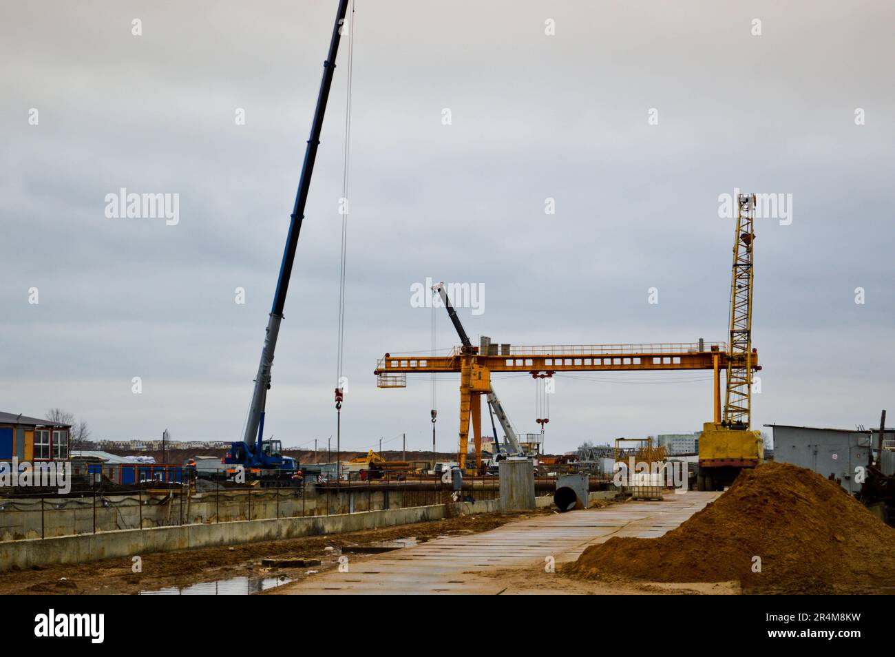 A construction site with specialized professional equipment and cranes ...