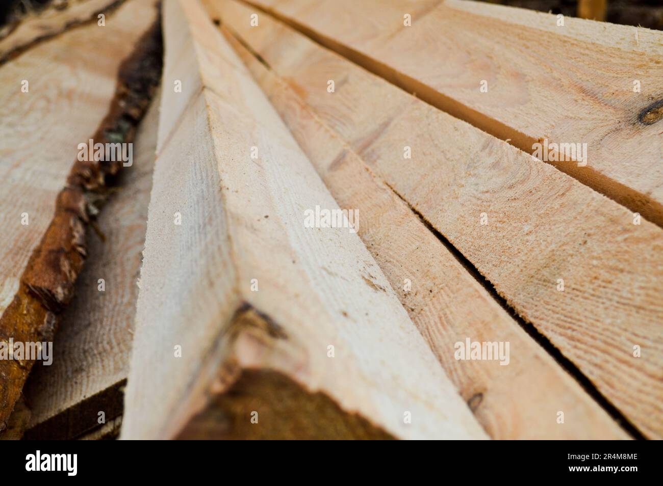 Lots of long wooden natural planed boards and sticks at a sawmill. The ...