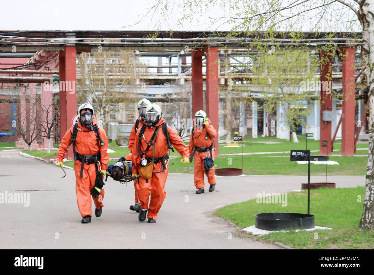 Four professional firefighter firefighters in orange protective ...