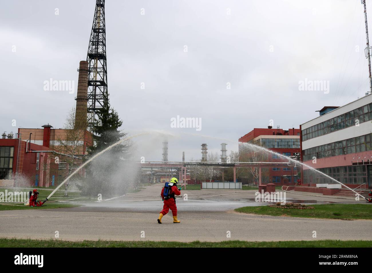 Professional firefighters in orange fire-resistant suits in white ...