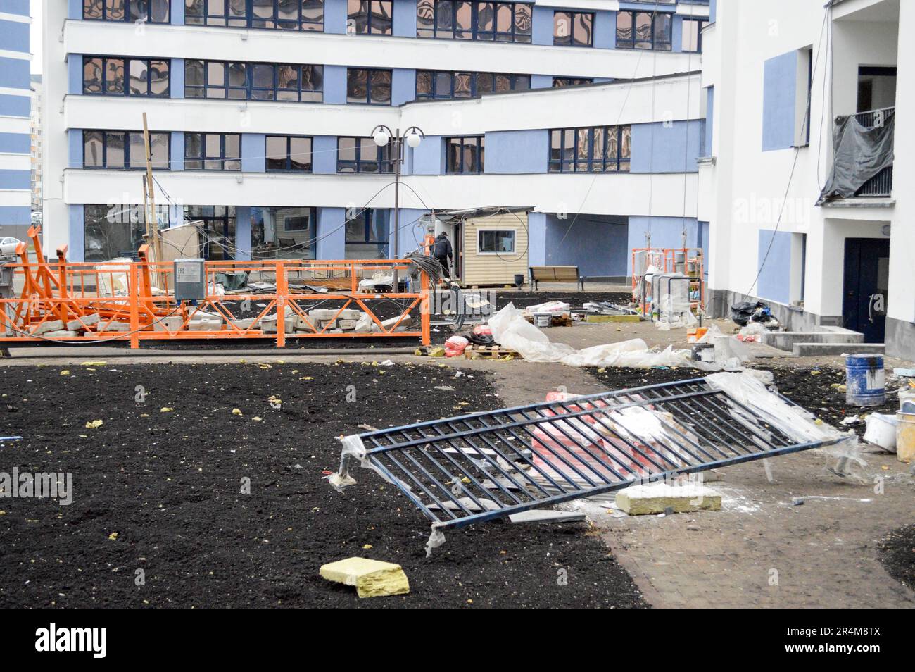 A mess at a construction site with scattered building materials and ...