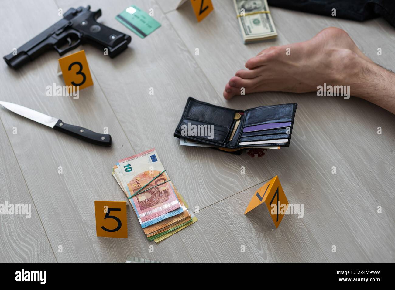Hand of dead victim surrounded by evidence markers and objects on floor ... Hand of dead victim surrounded by evidence markers and objects on floor ...