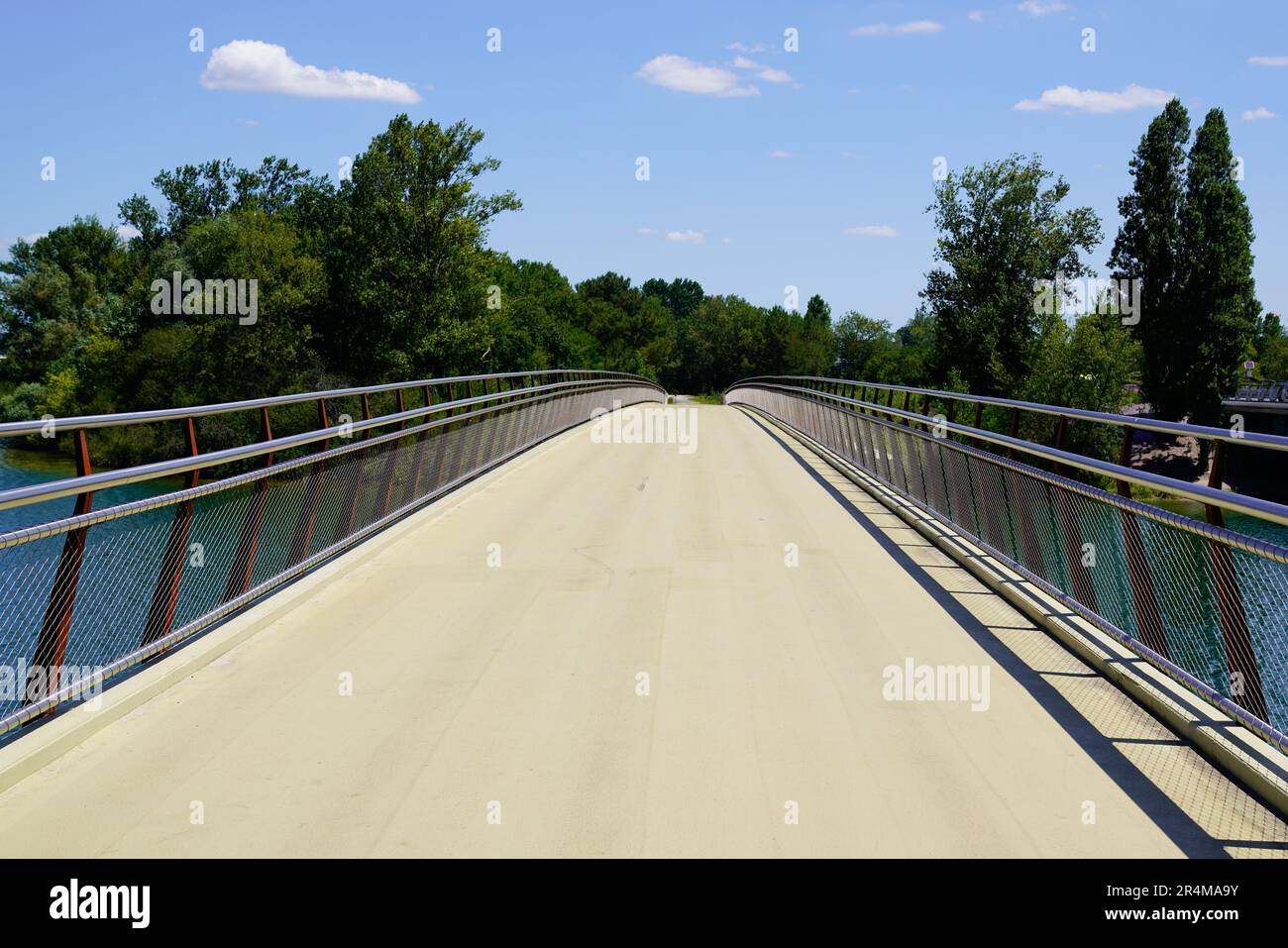 Overground empty bridge over the river for pedestrians round building ...