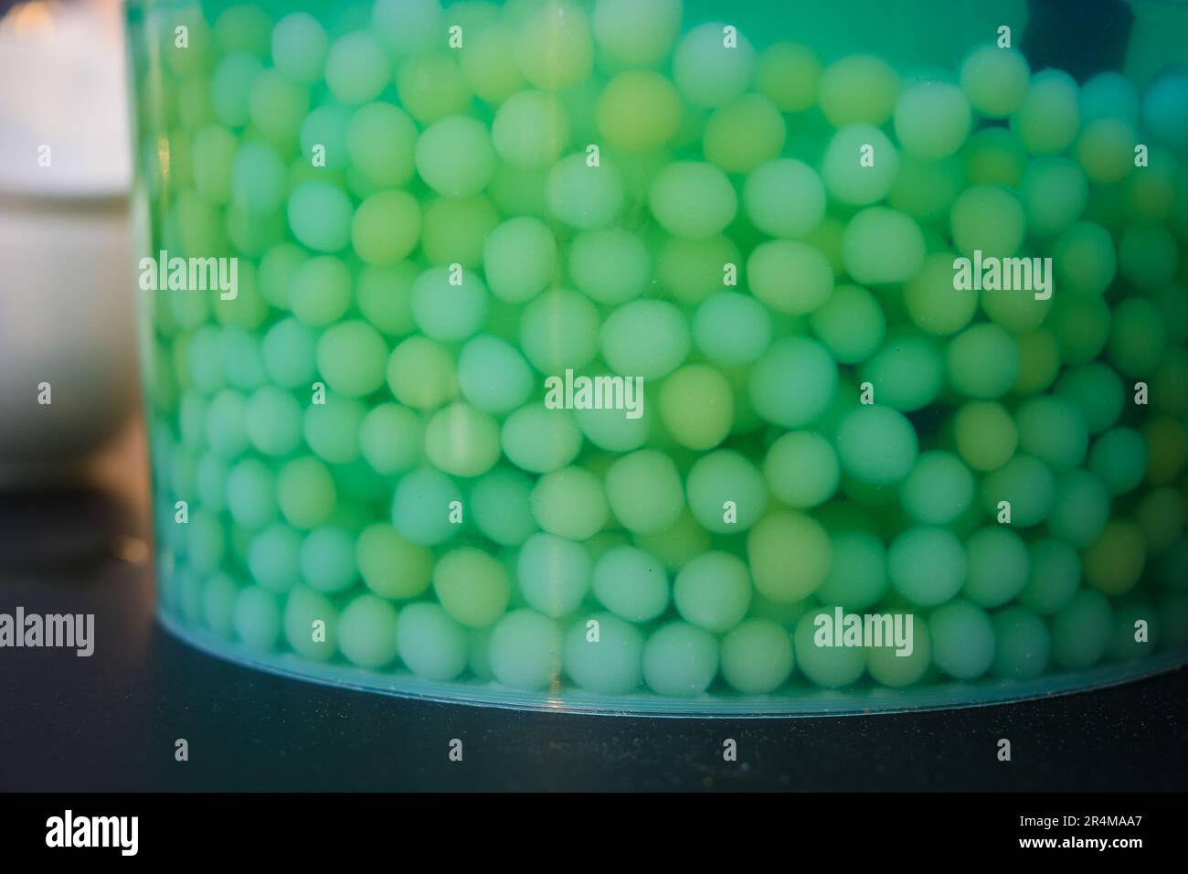 Large bucket full of green boba balls in liquid Stock Photo - Alamy