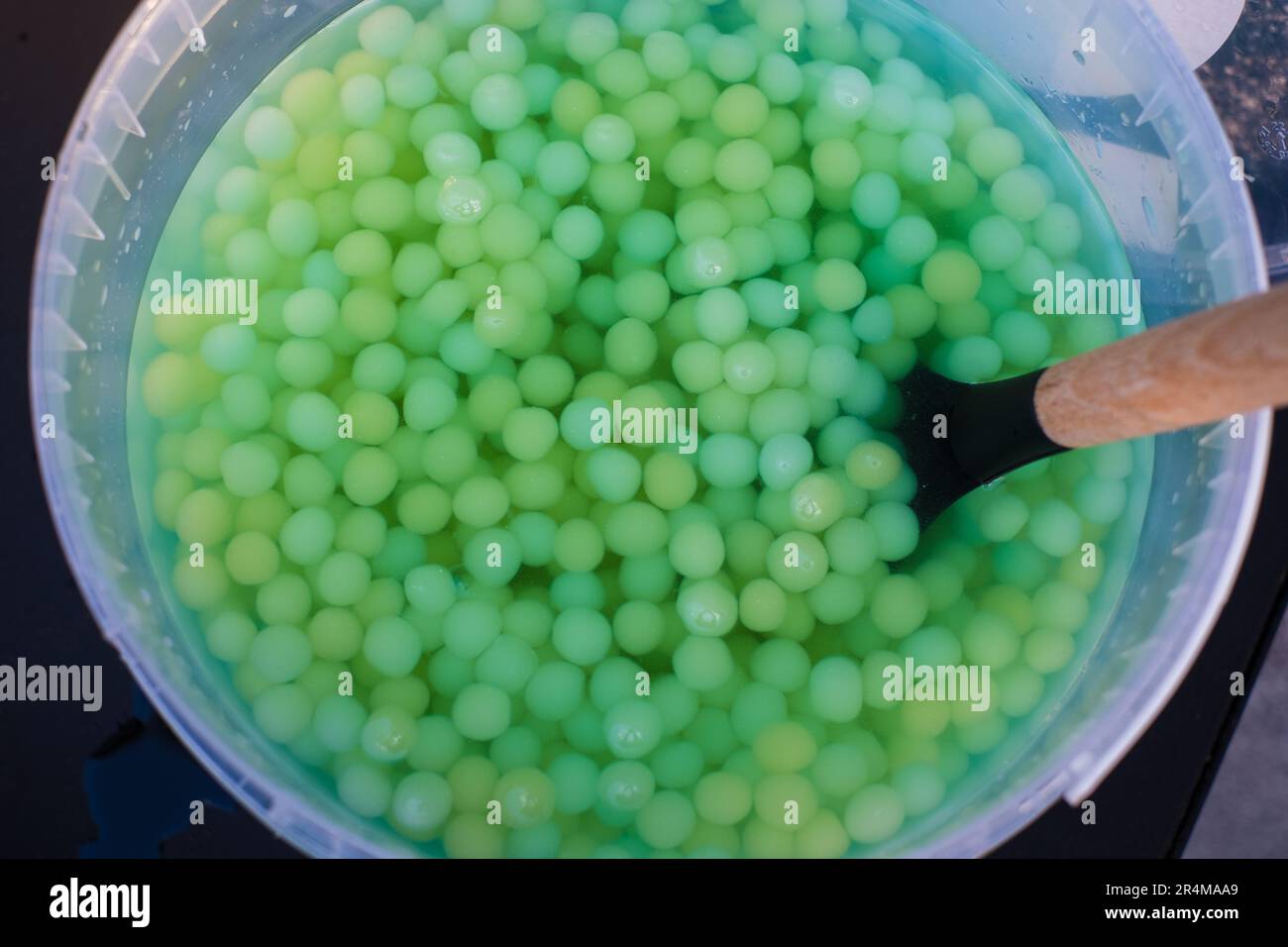 Large bucket full of green boba balls in liquid Stock Photo - Alamy