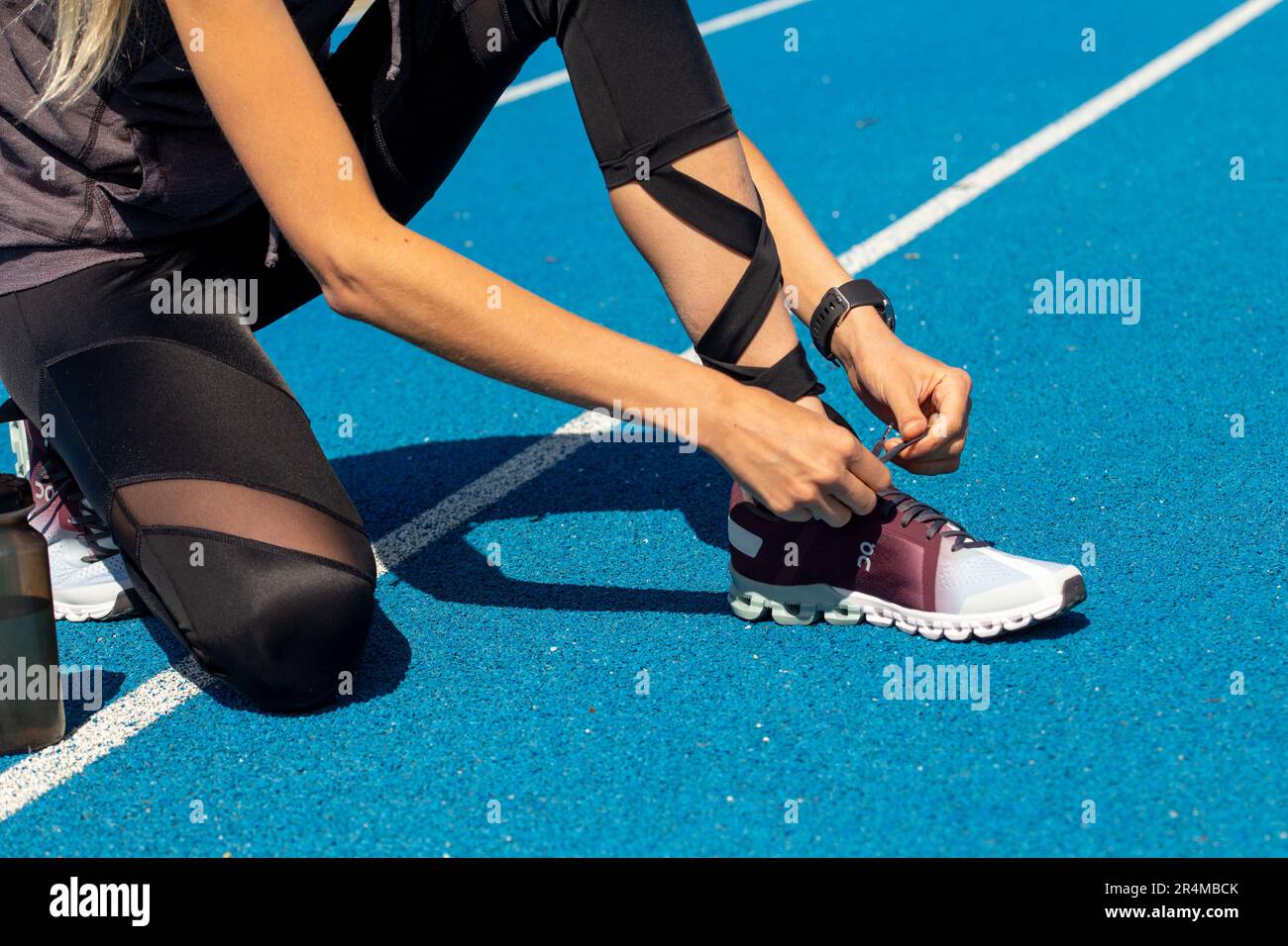Young female athlete wears running shoes from the Swiss shoe brand ON ...