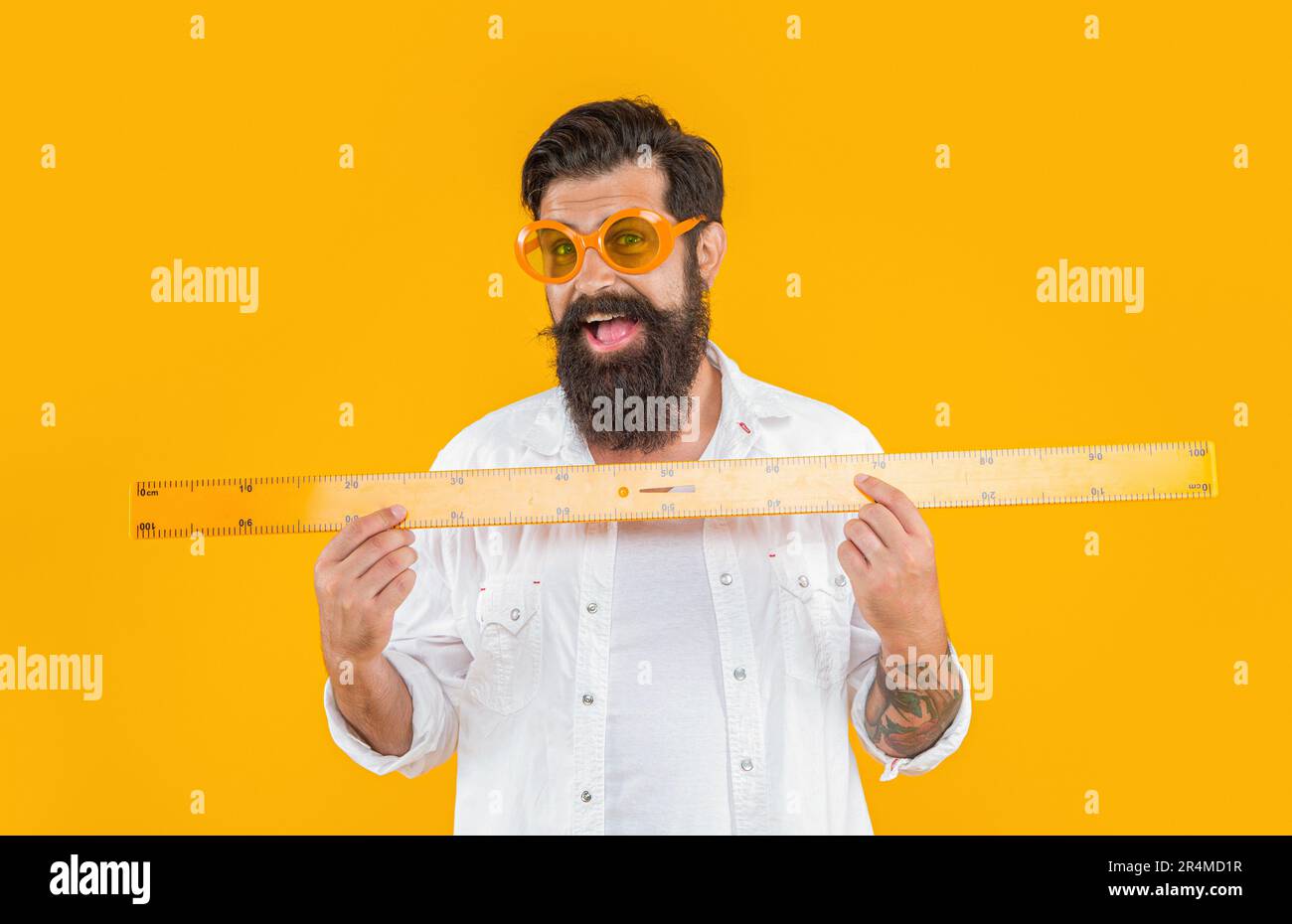 smiling man hold geometry ruler on background. photo of man hold ...