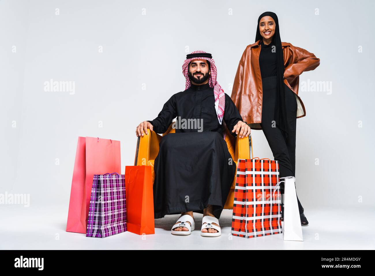 Beautiful saudi arabian middle-eastern happy couple of lovers wearing traditional abaya and ...