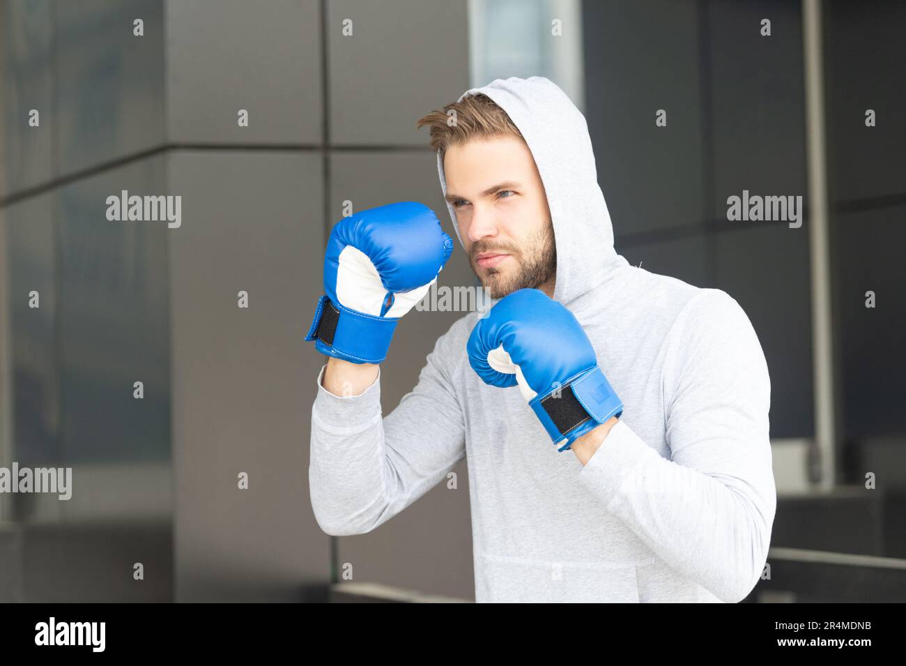 man boxing. man boxing in hoodie and gloves. man boxing outdoor. photo ...