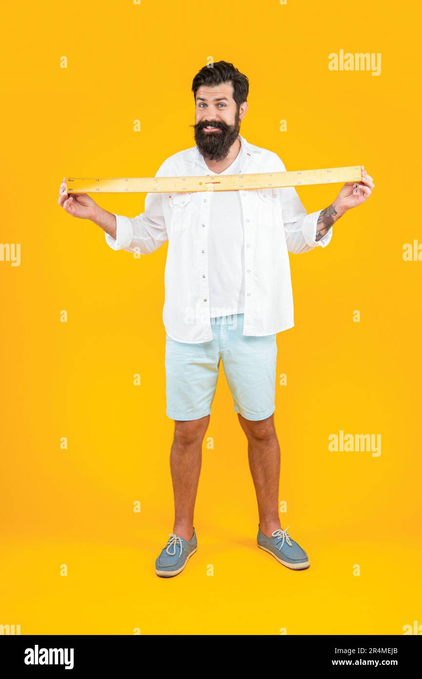 happy man with measuring ruler isolated on yellow. man with measuring ...