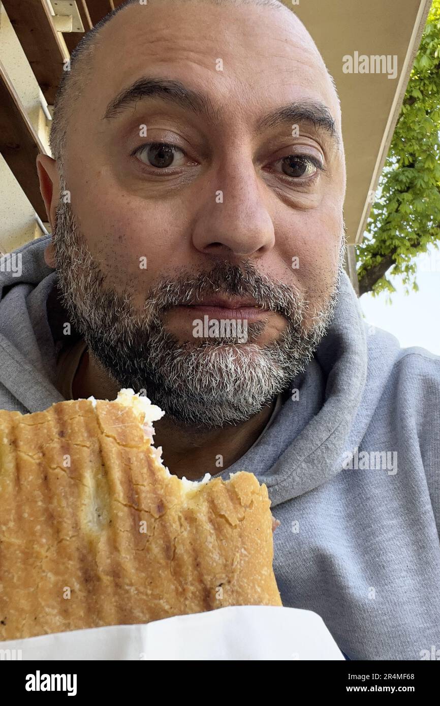 Man eating a sandwich Stock Photo - Alamy