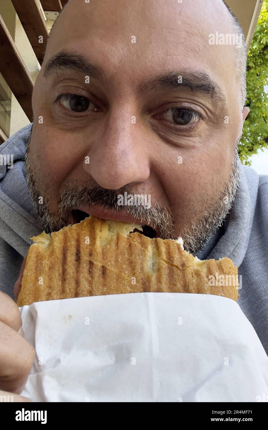 Man eating a sandwich Stock Photo - Alamy