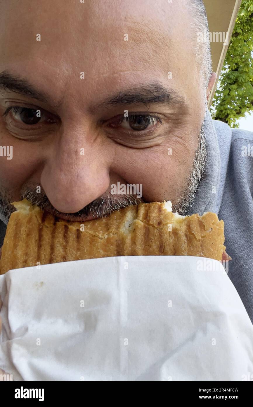 Man eating a sandwich Stock Photo - Alamy