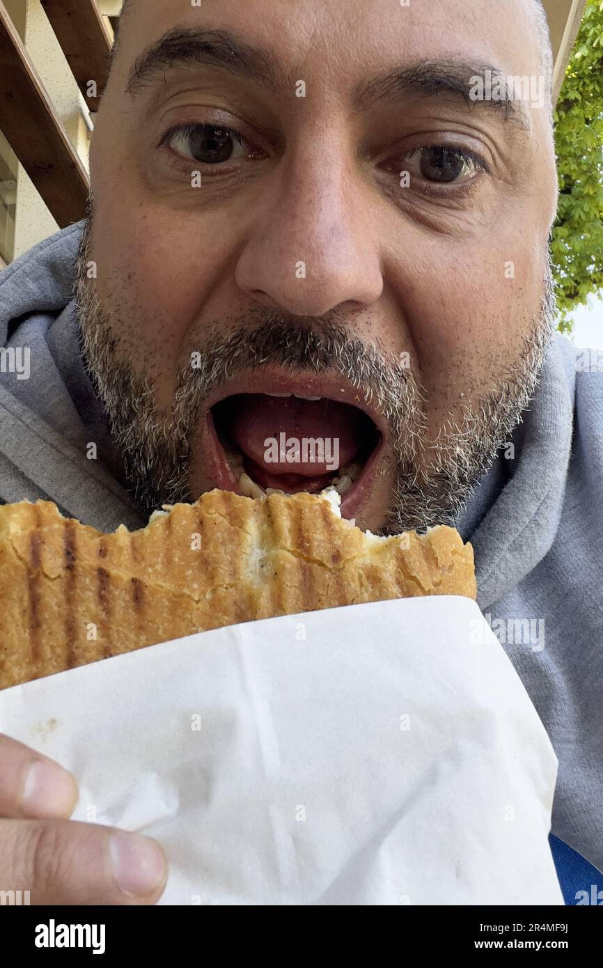 Man eating a sandwich Stock Photo - Alamy
