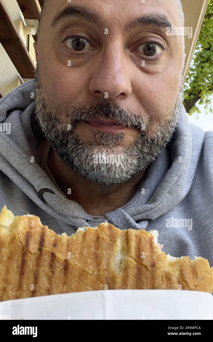 Man eating a sandwich Stock Photo - Alamy