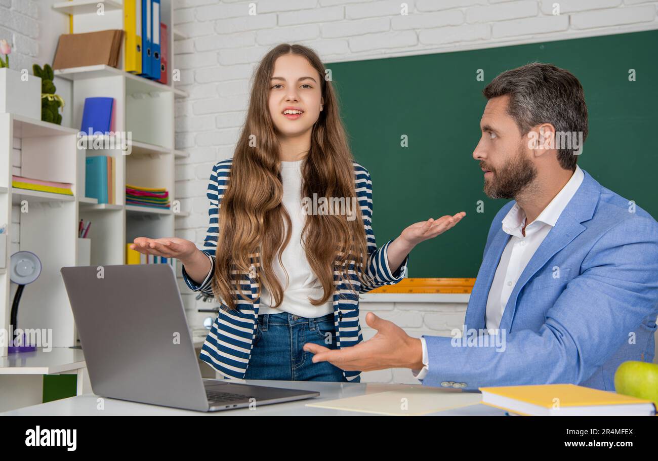 confused child with man teacher in classroom. education Stock Photo - Alamy