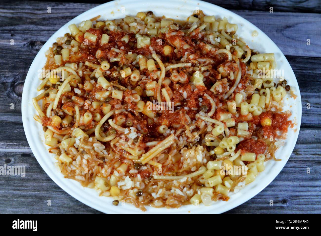 Egyptian cuisine of Koshary, a popular street food made of rice ...