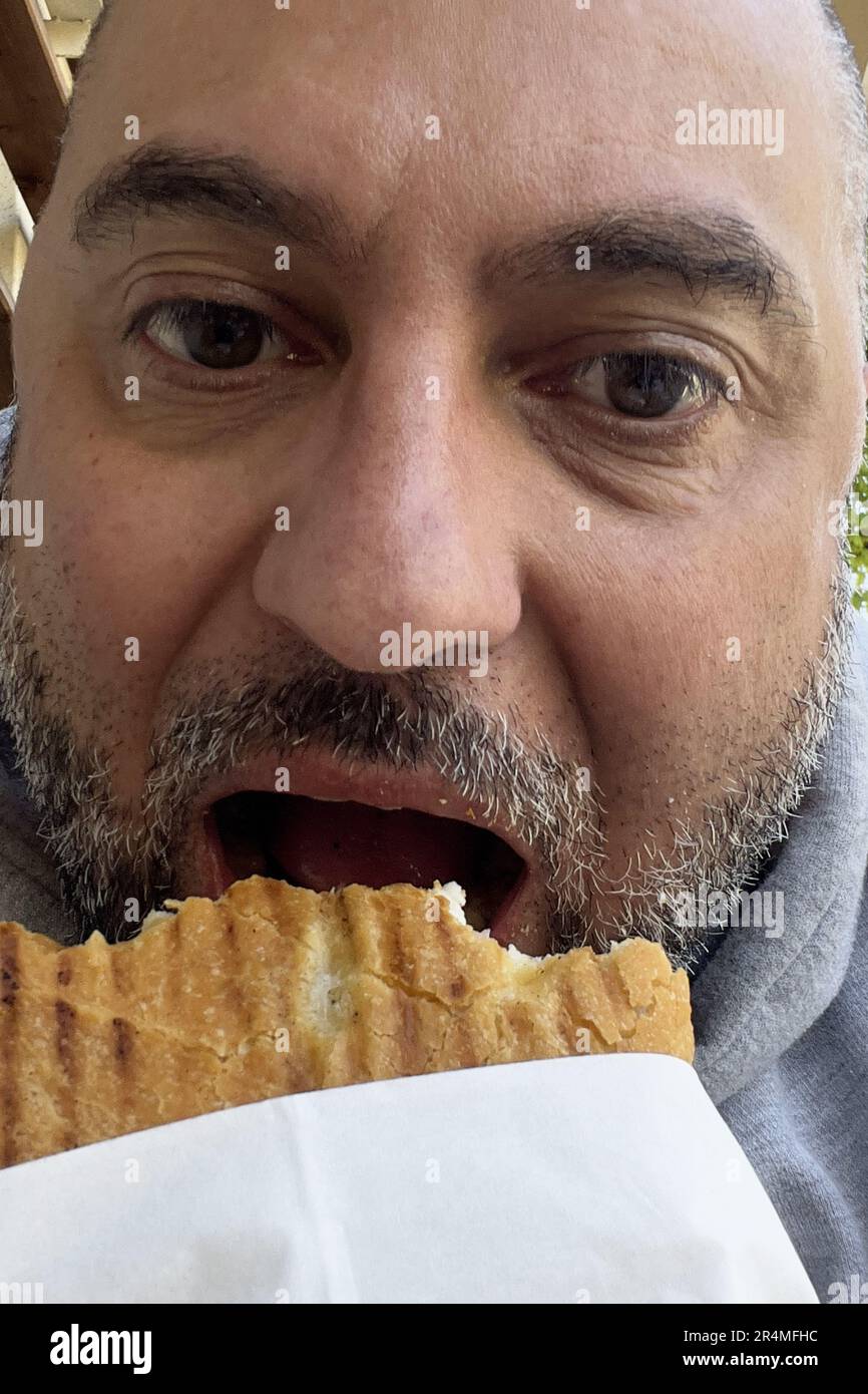Man eating a sandwich Stock Photo - Alamy