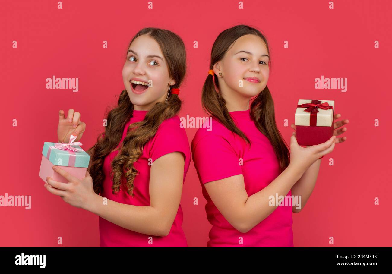happy kids with present boxes on red background Stock Photo - Alamy