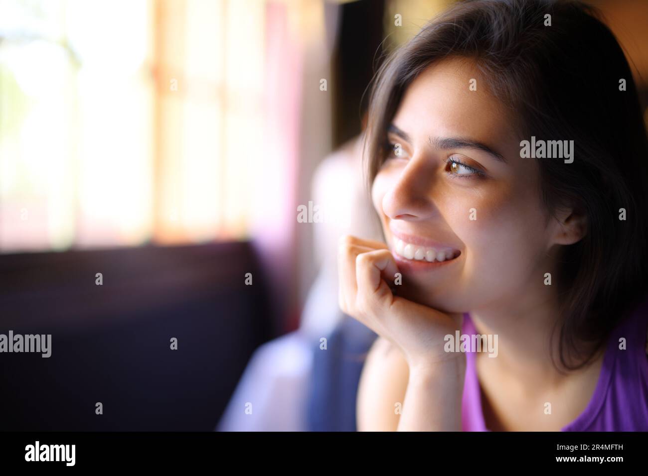 Happy beauty woman looking through a window in a house interior Stock ...