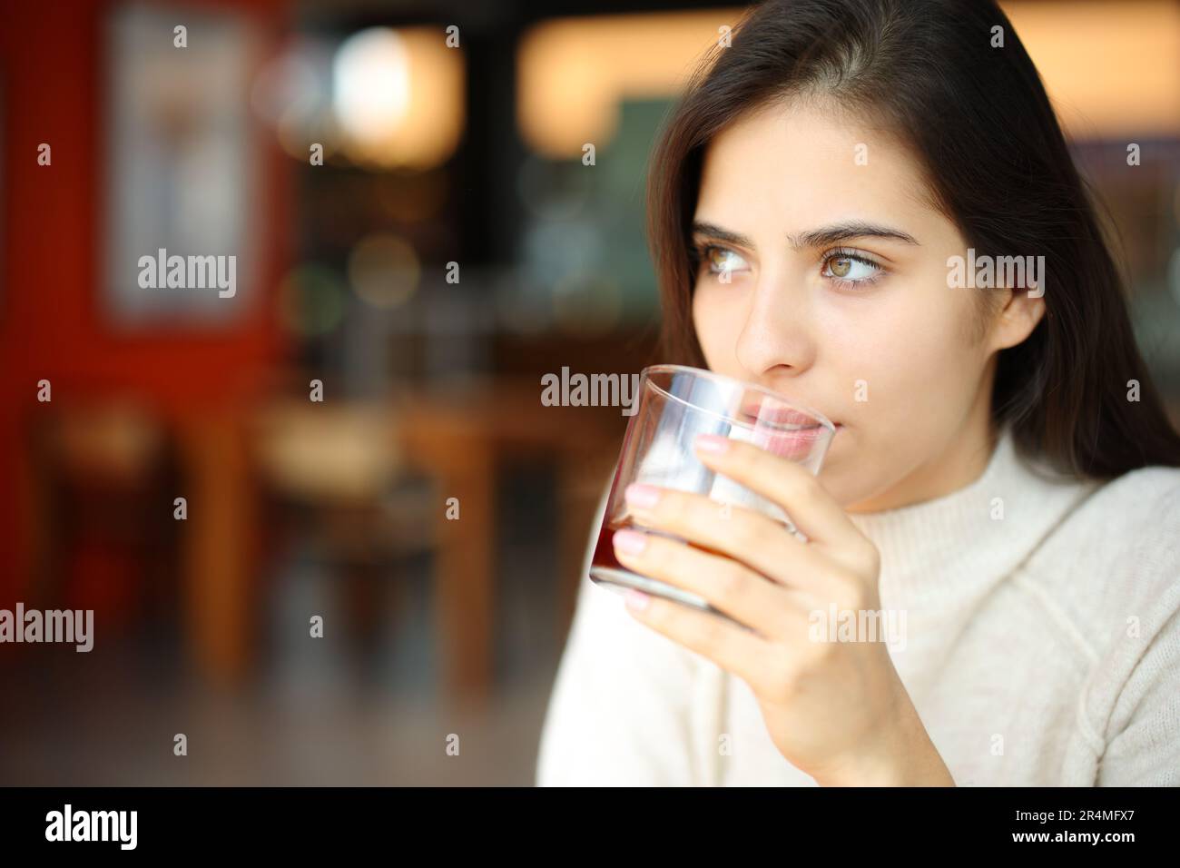 Restaurant customer drinking refreshment looking away Stock Photo - Alamy