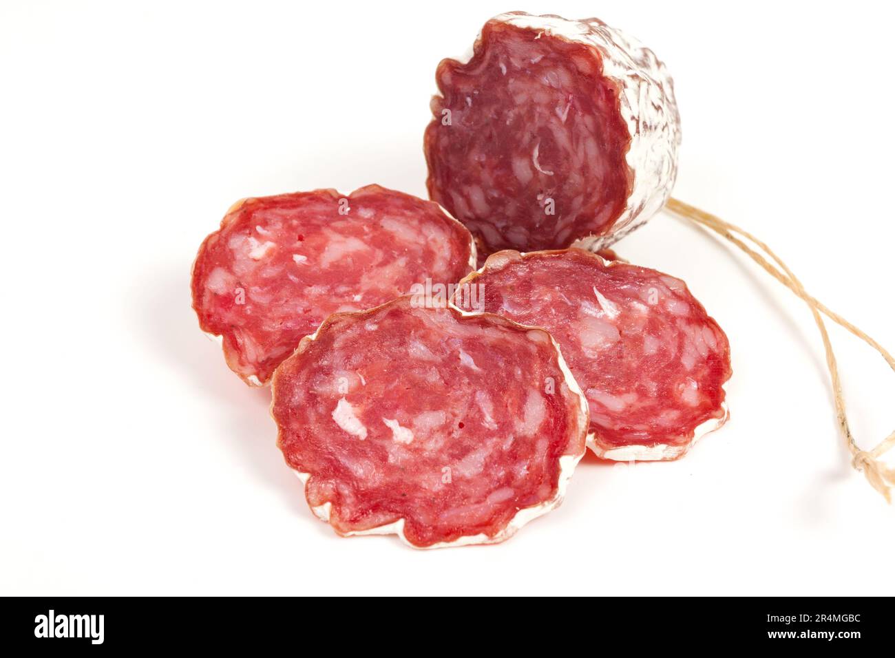 pile of red salami, isolated on a white background Stock Photo - Alamy