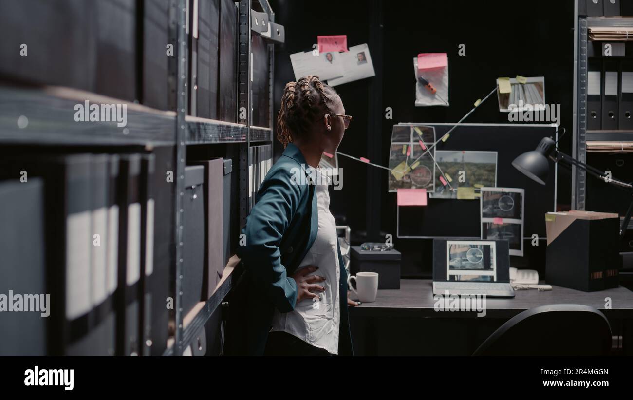 Law enforcement agent checking detective evidence map Stock Photo - Alamy