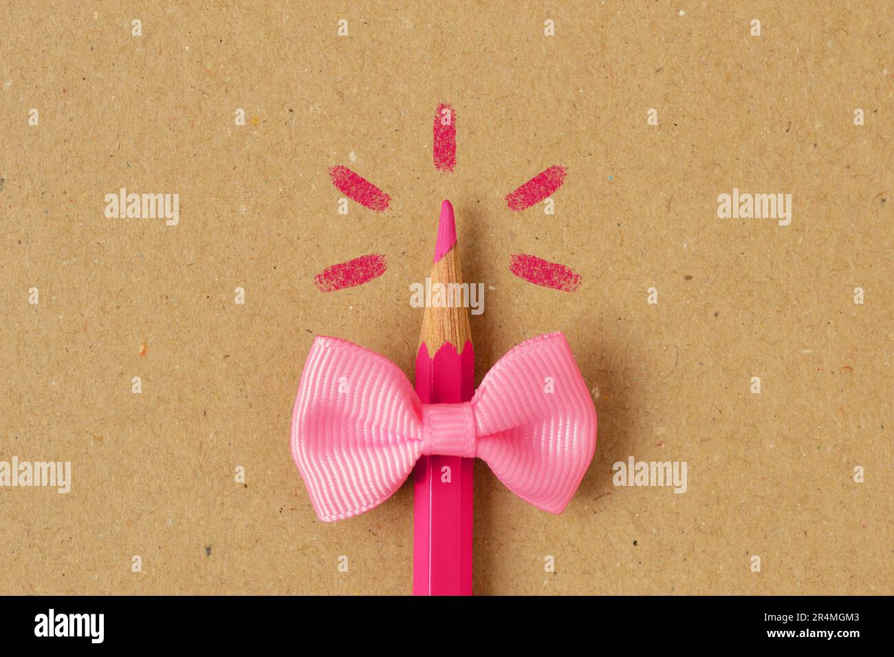 Pink pencil with pink bow tie on recycled paper background - Concept of ...