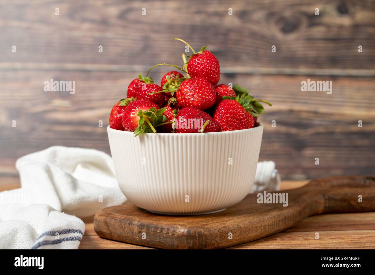 Strawberry in bowl. Organic farm products. Fresh strawberries on wooden ...