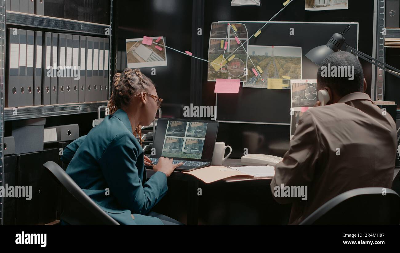 Team of detectives analyzing surveillance records Stock Photo - Alamy
