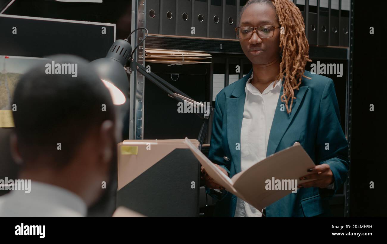 Detective partners discussing investigation and clues Stock Photo - Alamy