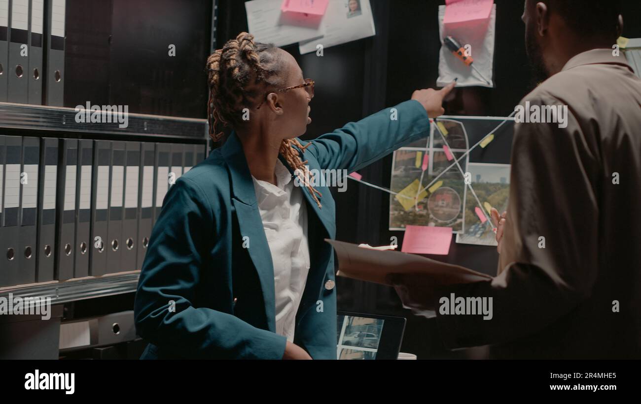 Police officers studying case files in incident room Stock Photo - Alamy