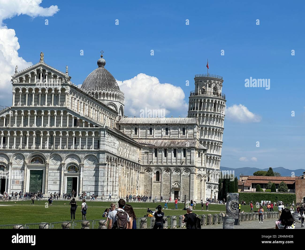 tourists at the Piazza del Duomo of Pisa, with the leaning tower of ...