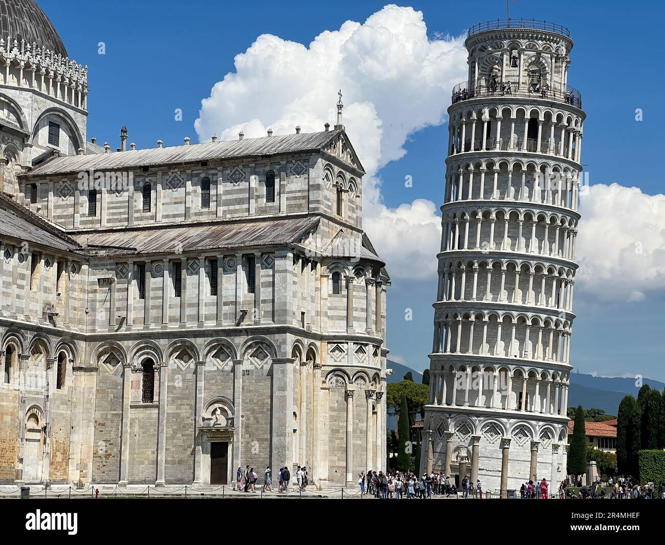 tourists at the Piazza del Duomo of Pisa, with the leaning tower of ...