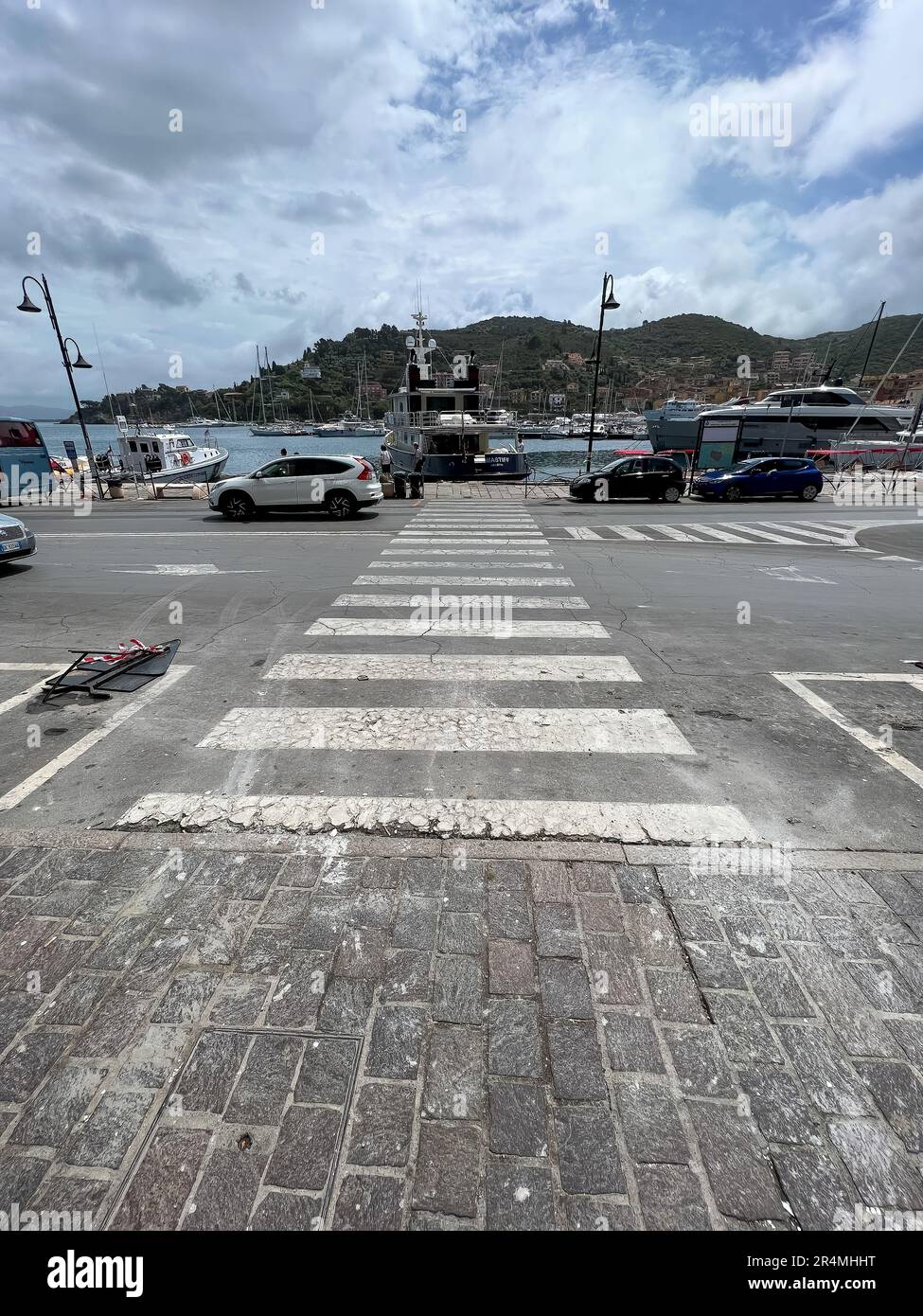 zebra crossing leading to harbour and moored boats Stock Photo - Alamy