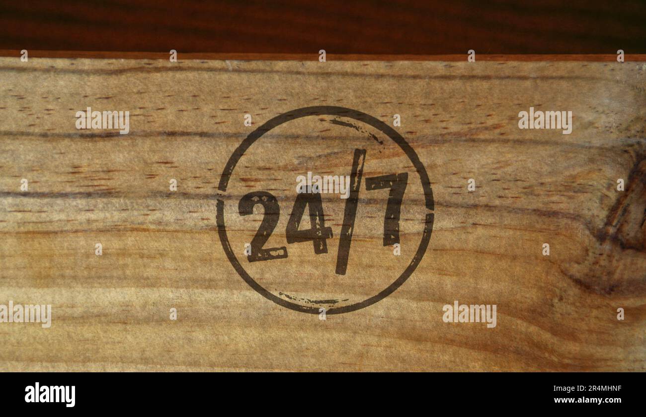 24 by 7 24 hour a day service stamp printed on wooden box. 24h round ...