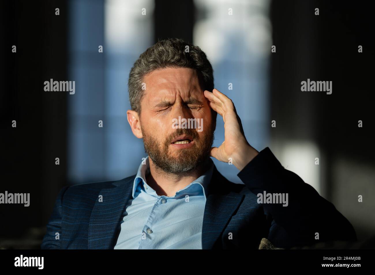 Man with sinus headache, tension or cluster headache, close up portrait ...